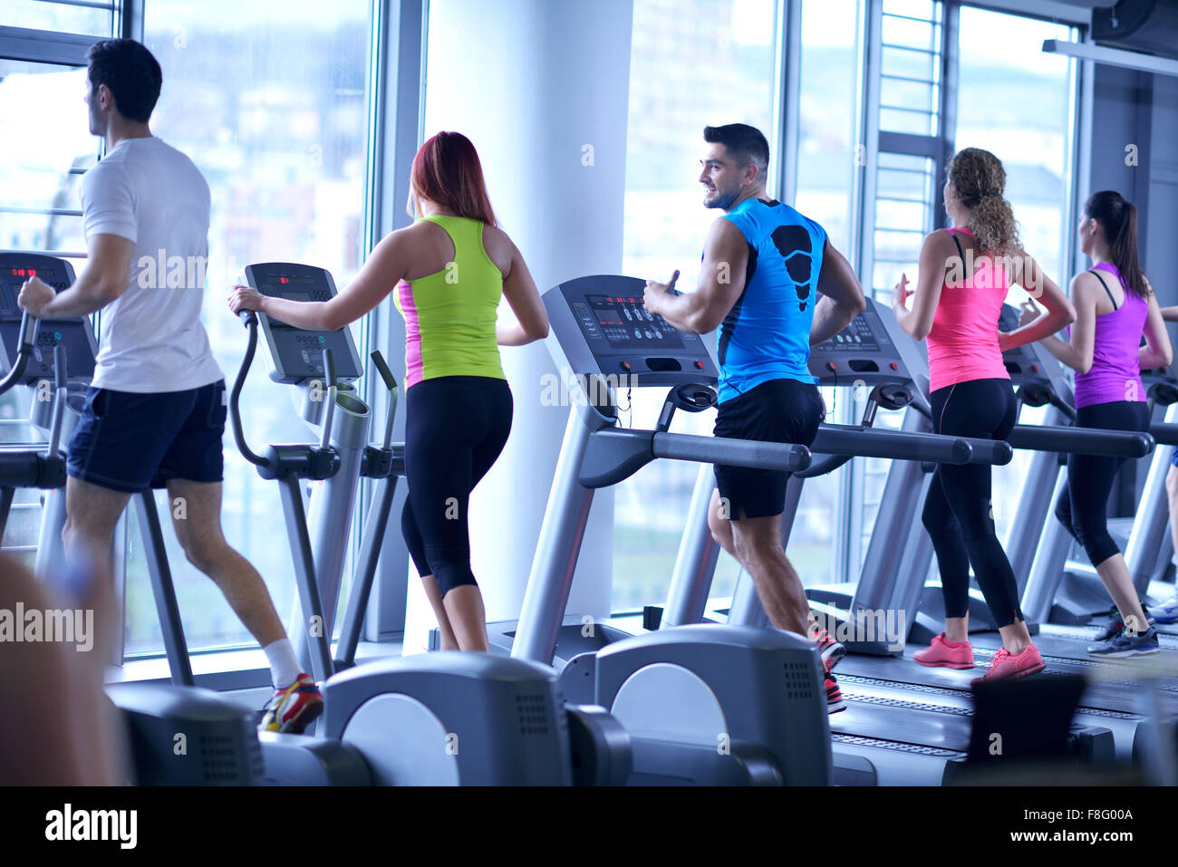 group of young people running on treadmills in modern sport gym Stock ...