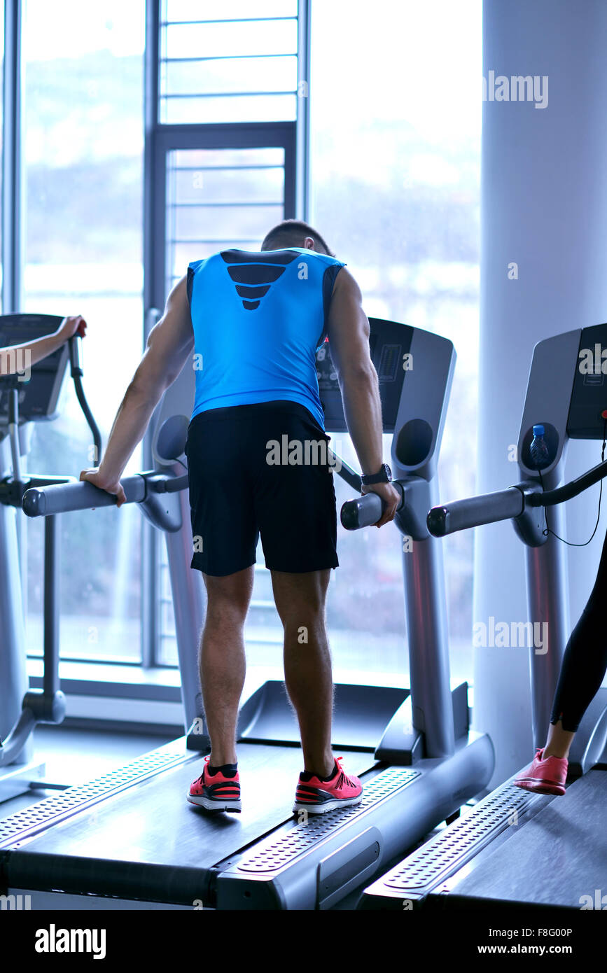 Handsome man running on the treadmill in modern gym Stock Photo - Alamy