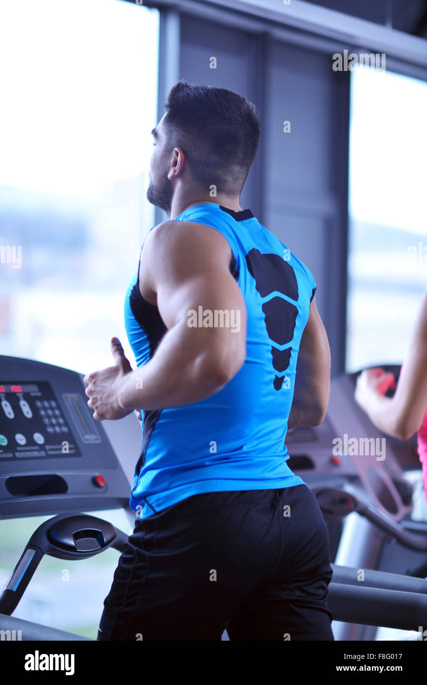 Handsome man running on the treadmill in modern gym Stock Photo - Alamy