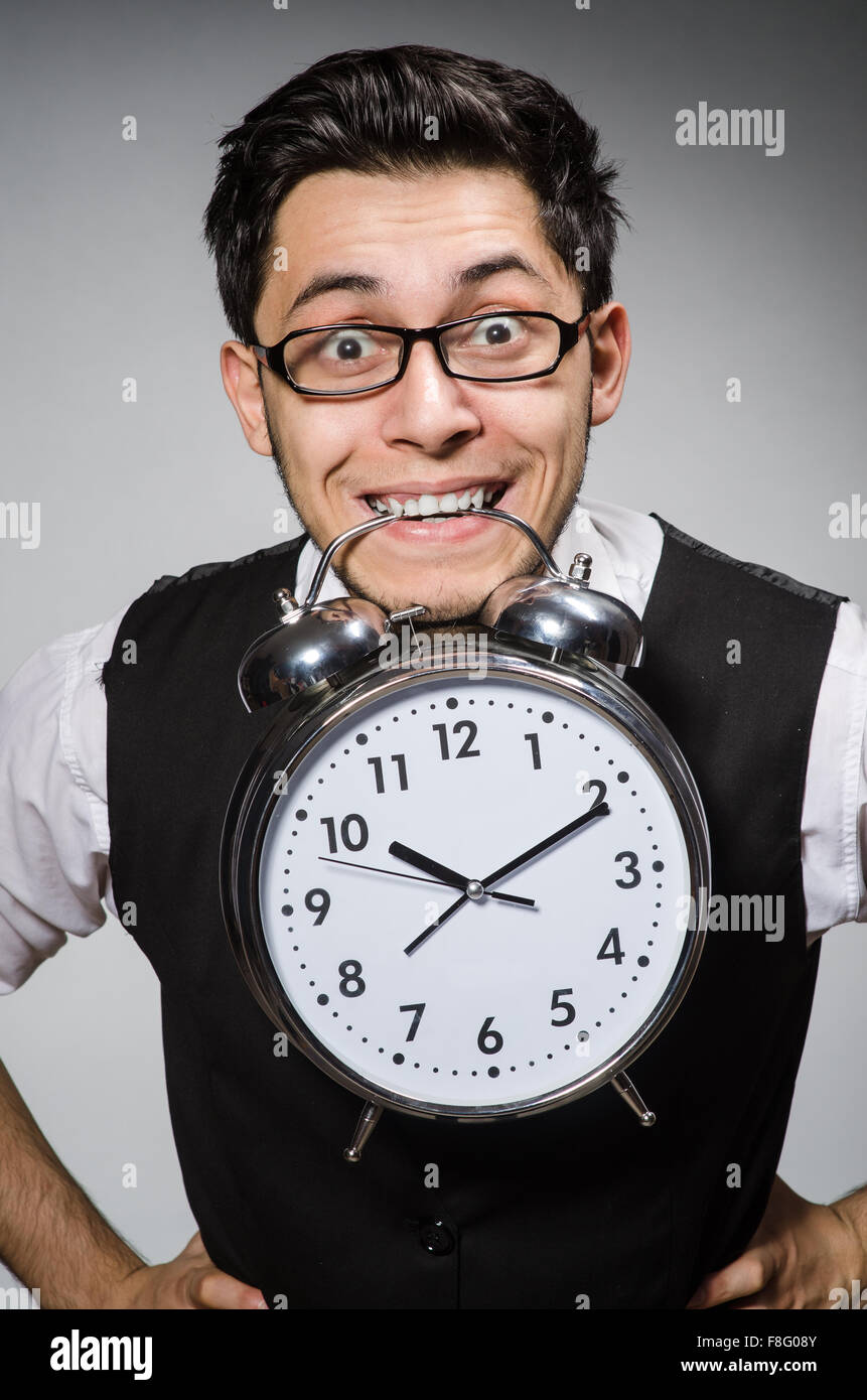 Businessman with clock in time concept Stock Photo - Alamy