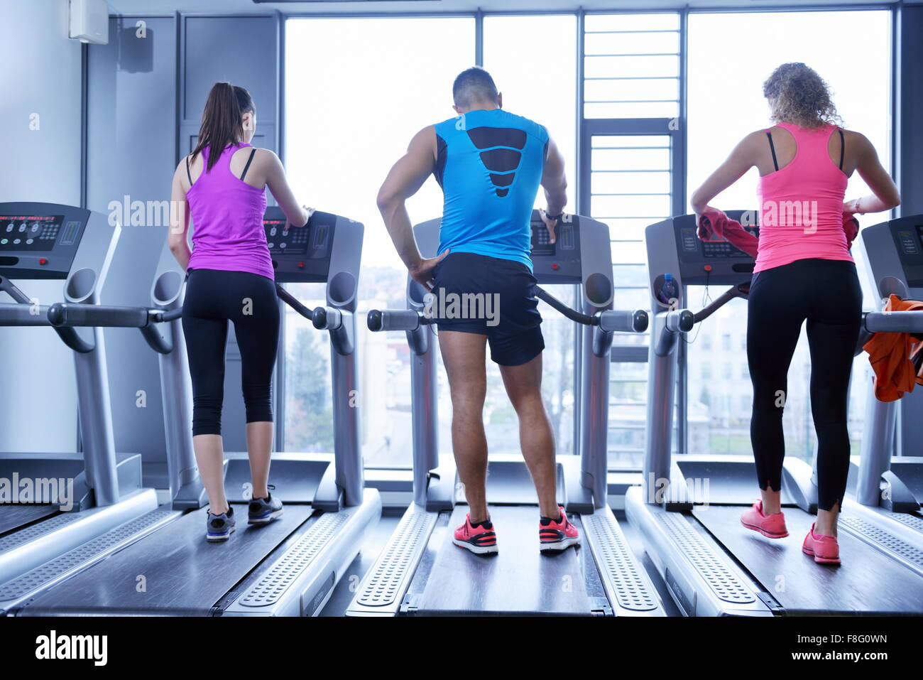 group of young people running on treadmills in modern sport gym Stock ...