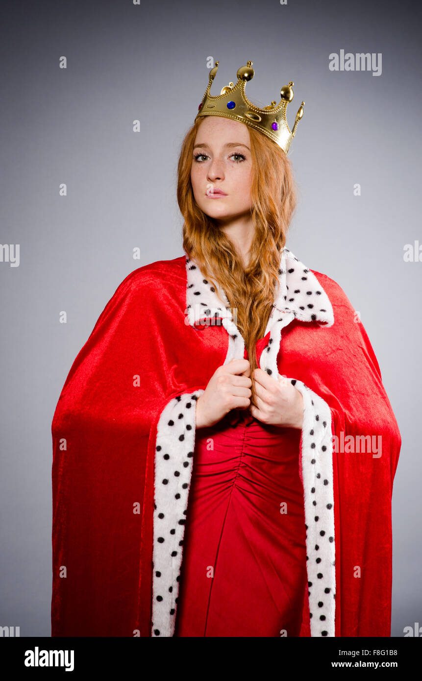 Queen in red dress in studio Stock Photo - Alamy
