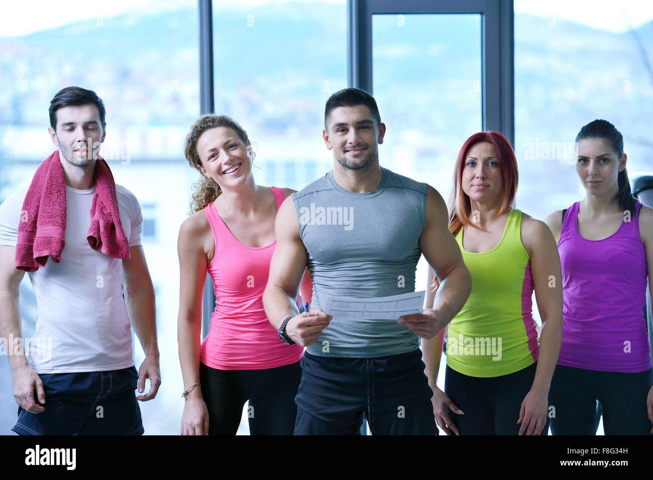 Group of people exercising at the gym and stretching Stock Photo - Alamy