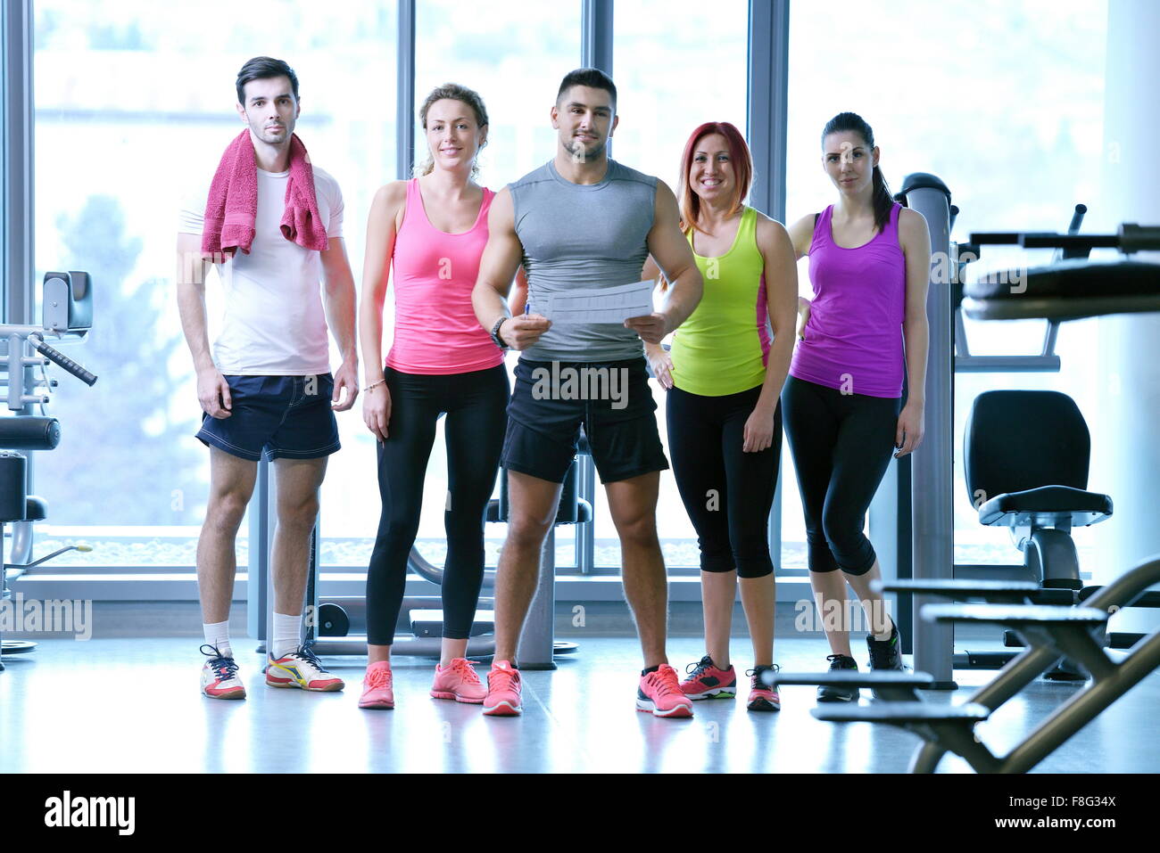 Group of people exercising at the gym and stretching Stock Photo - Alamy