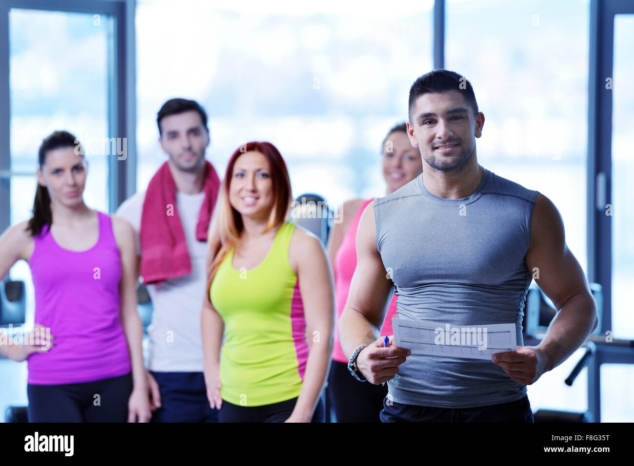 Group of people exercising at the gym and stretching Stock Photo - Alamy