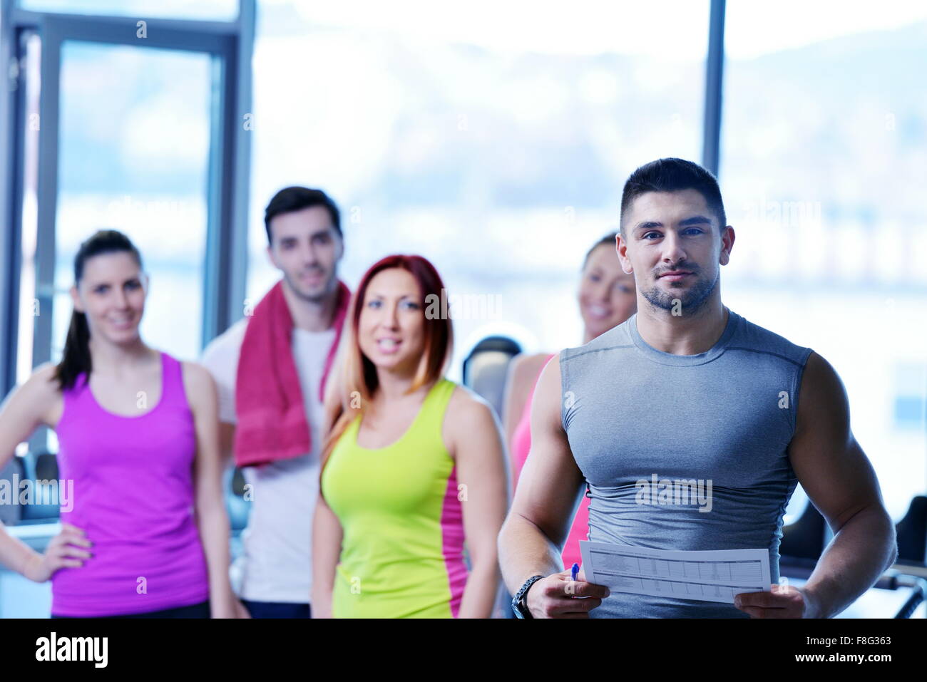Group of people exercising at the gym and stretching Stock Photo - Alamy
