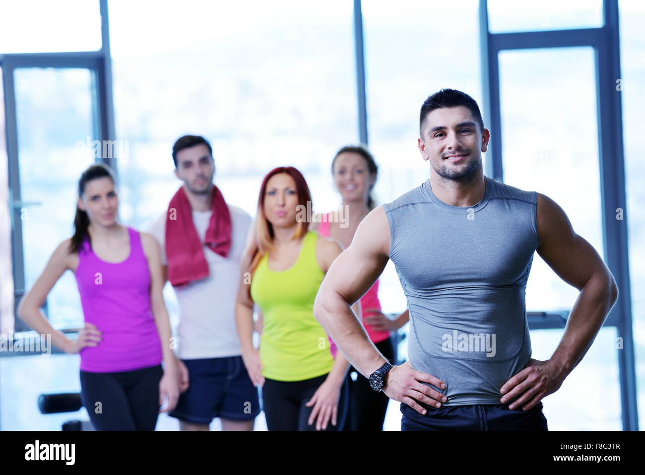 Group of people exercising at the gym and stretching Stock Photo - Alamy