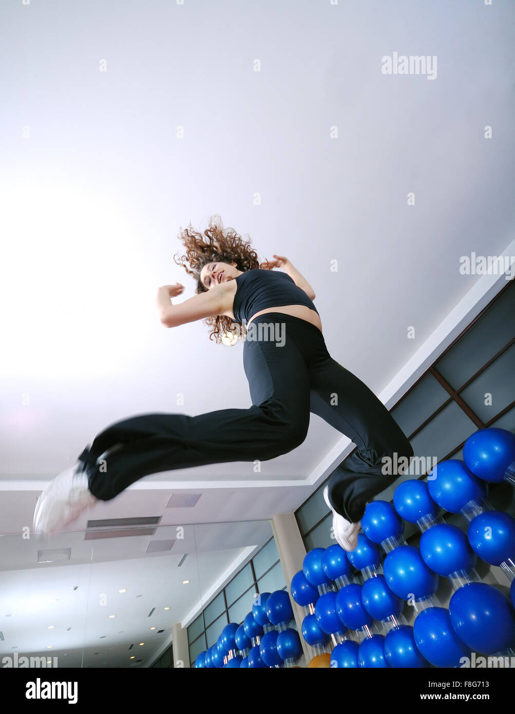 Dancing woman, happy and jumping up Stock Photo - Alamy