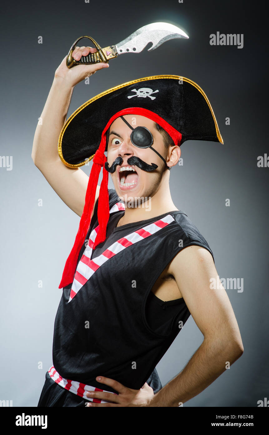 Funny pirate in the dark studio Stock Photo - Alamy