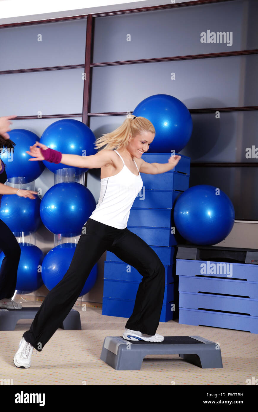 woman stepping in a fitness center Stock Photo - Alamy