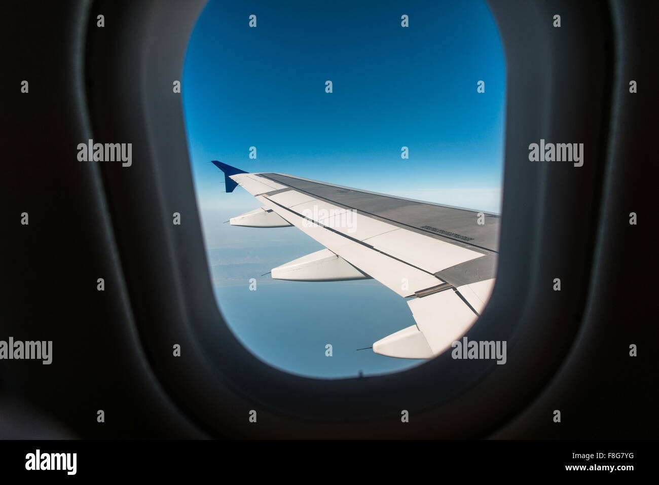 Airplane wing out of window Stock Photo - Alamy