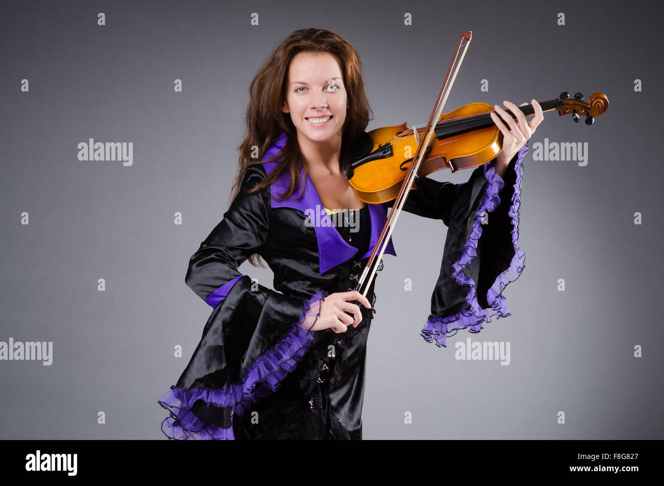 Woman artist with violin in music concept Stock Photo - Alamy