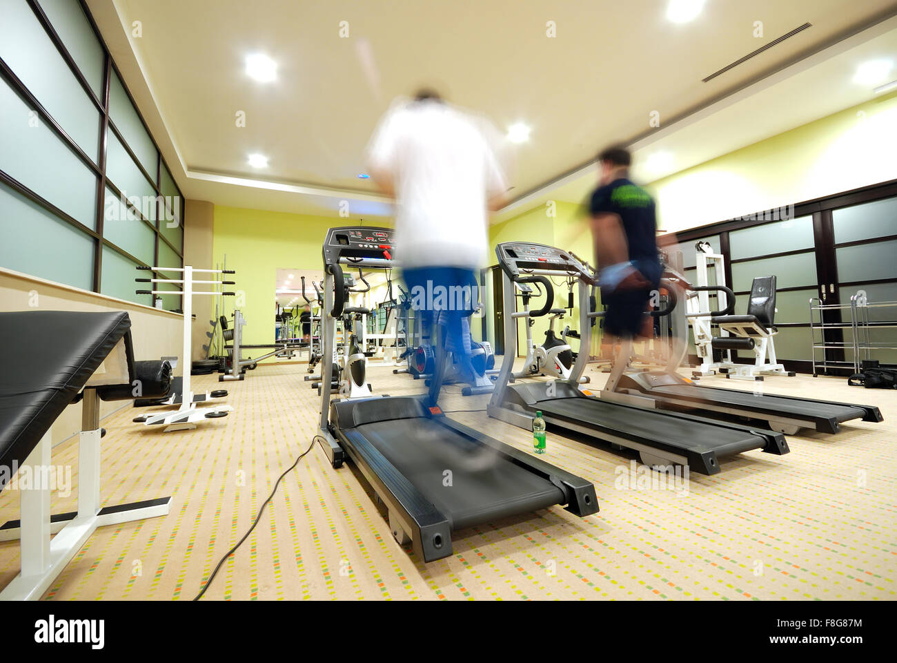 Man running on treadmill in gym Stock Photo - Alamy