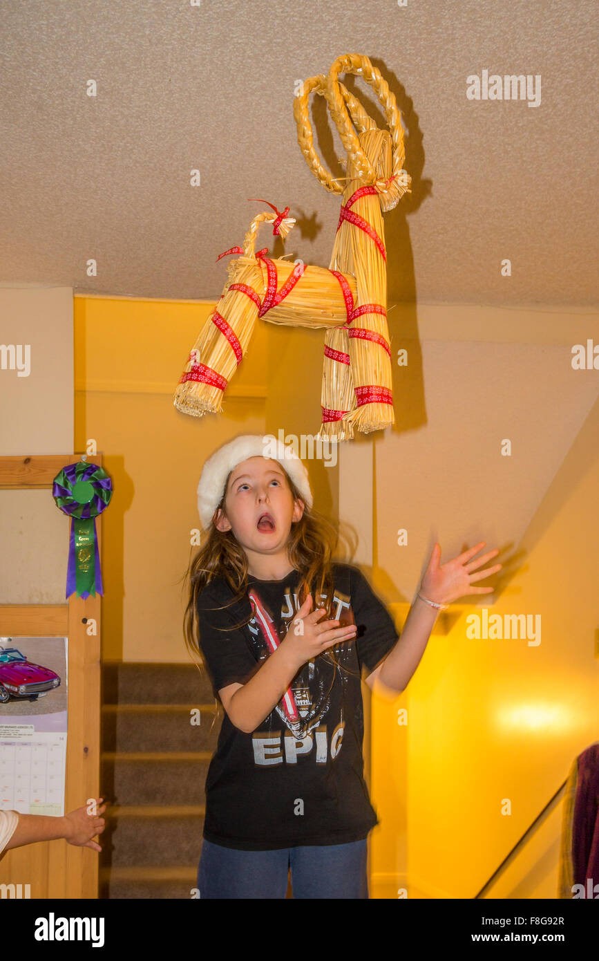 Boy throwing straw animal up in the air Stock Photo - Alamy