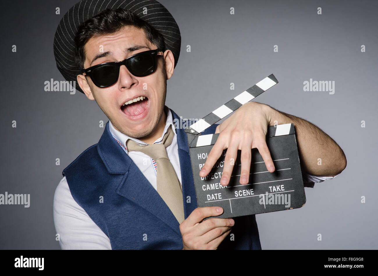 Funny man with movie clapper Stock Photo - Alamy