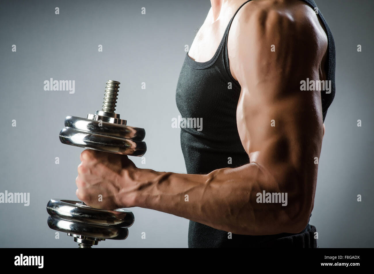 Muscular ripped bodybuilder with dumbbells Stock Photo - Alamy