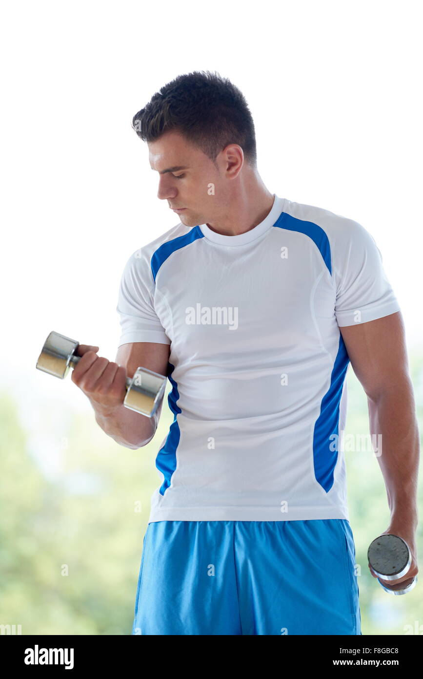 young man in fintess sport club exercise with weights and relaxing ...
