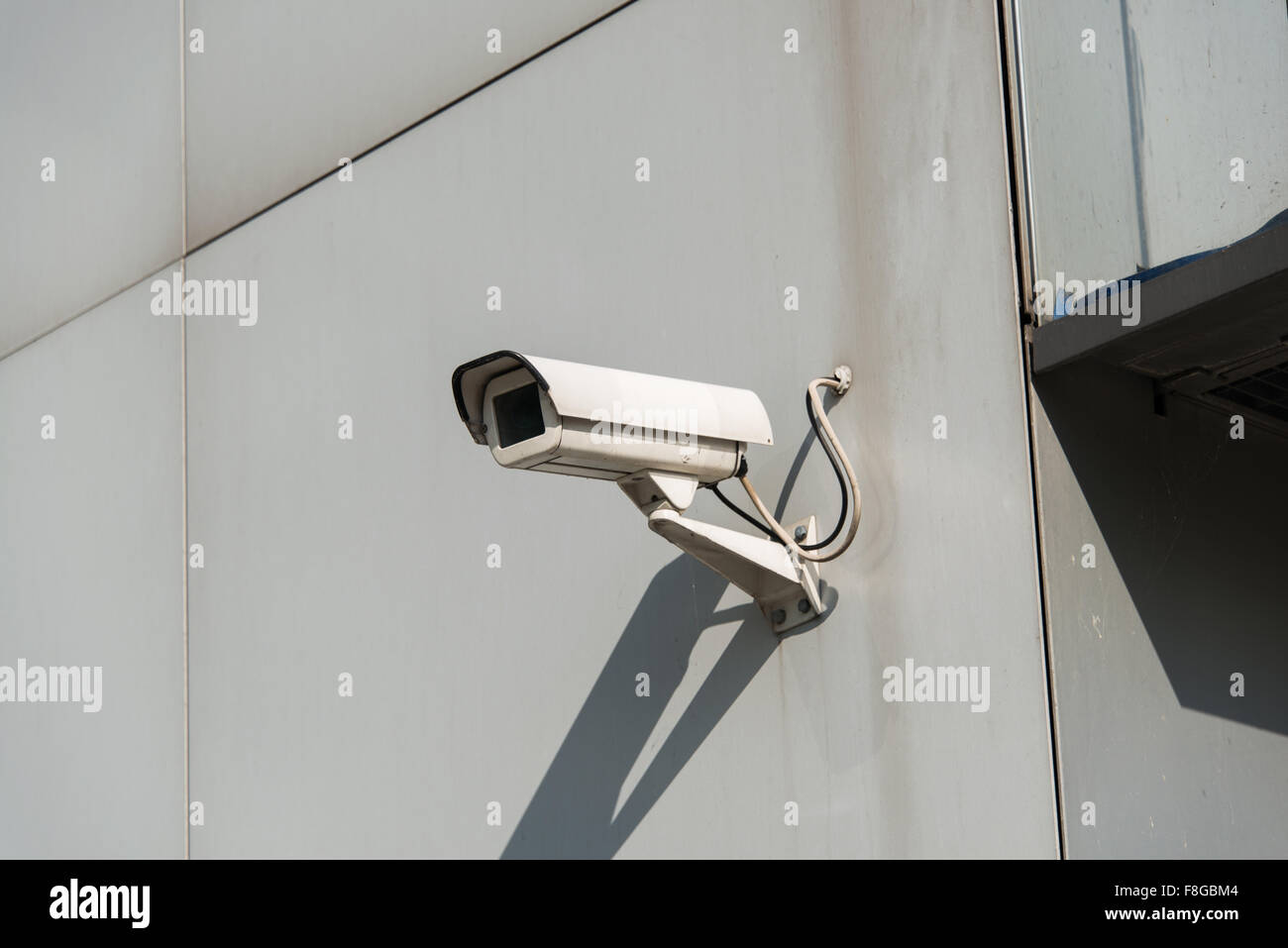Security camera attached to the wall Stock Photo - Alamy