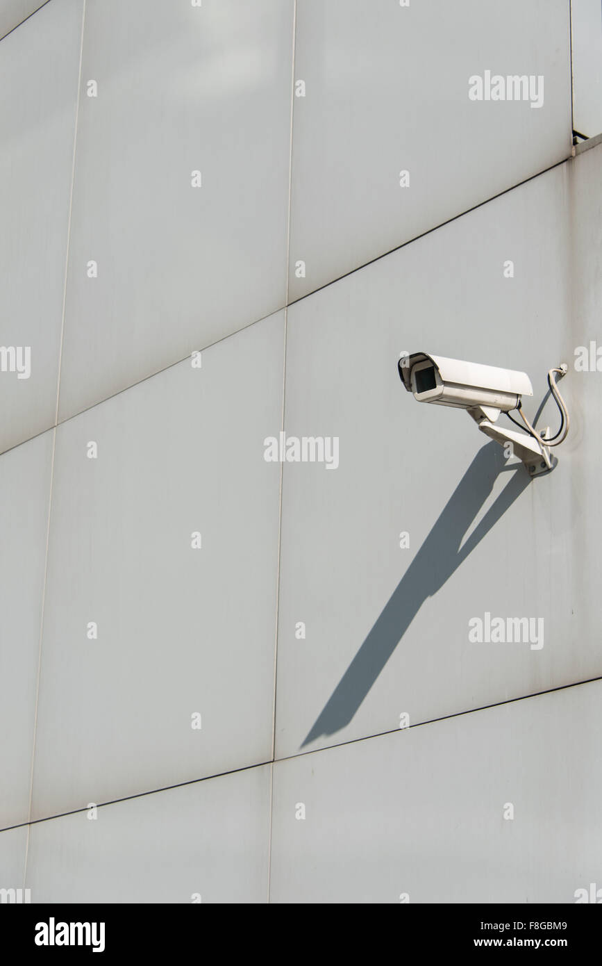 Security camera attached to the wall Stock Photo - Alamy