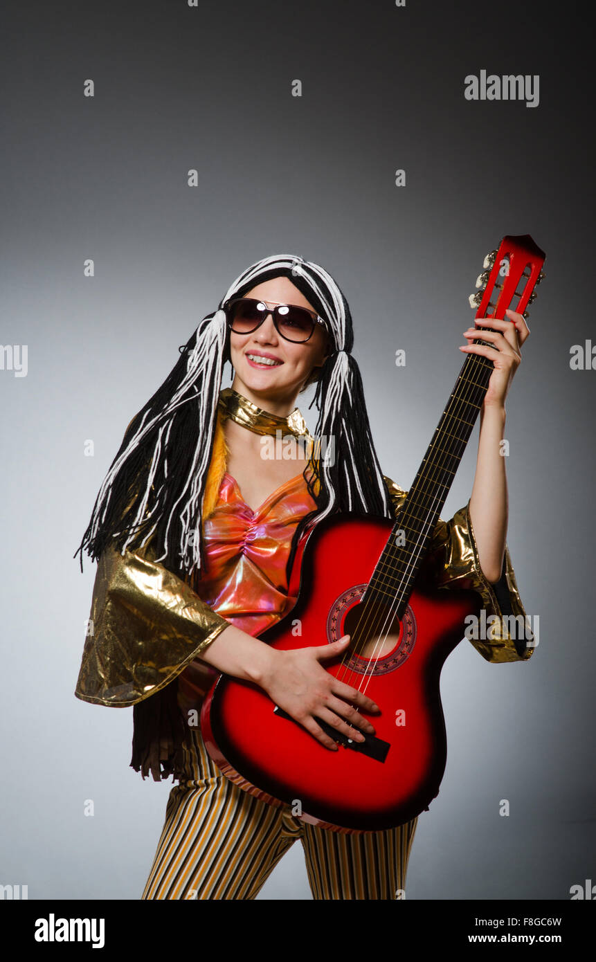 Guitar player with red instrument Stock Photo - Alamy