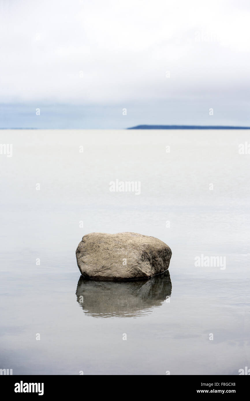 Rock floating in a lake Stock Photo - Alamy