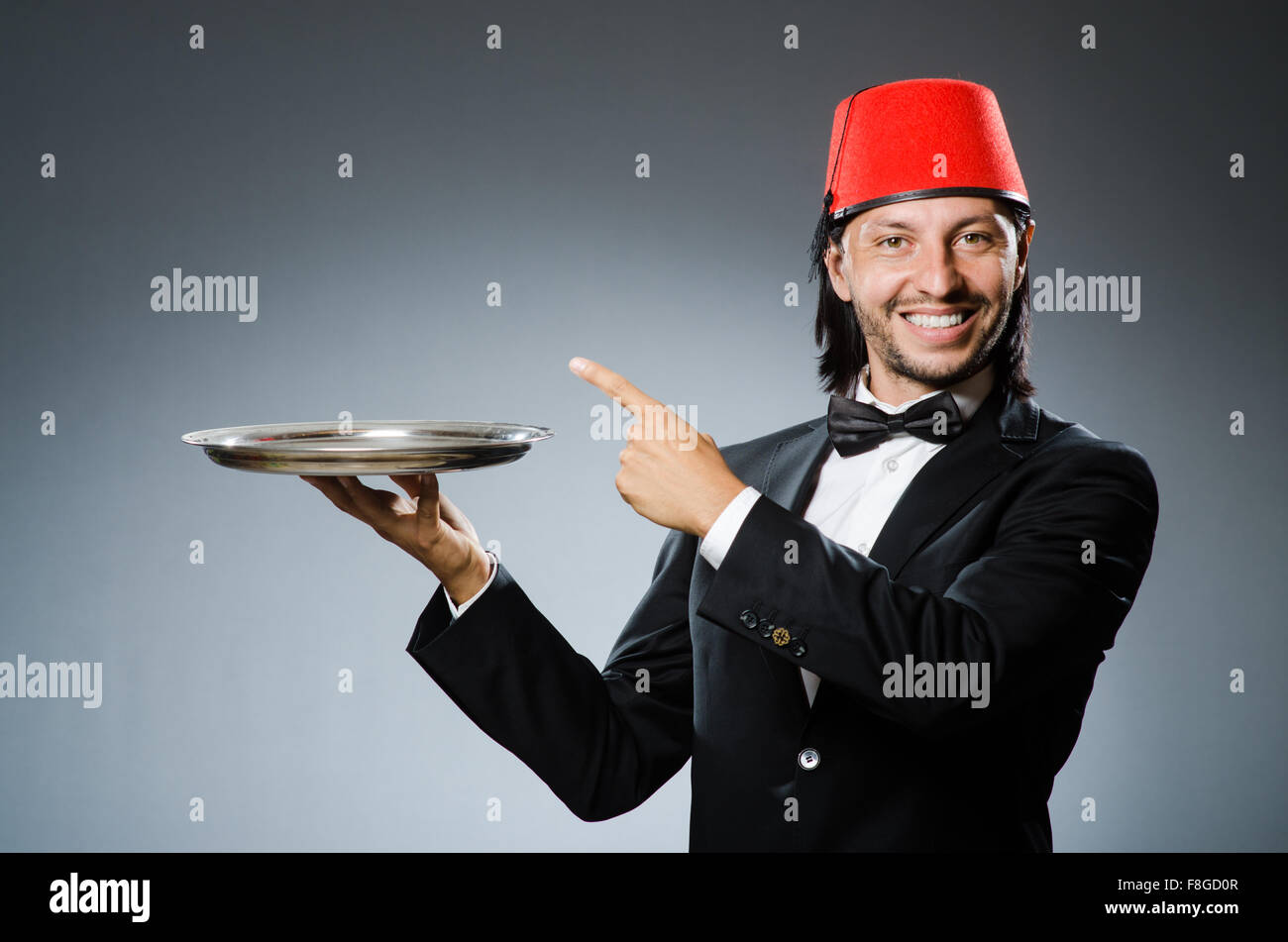Waiter wearing traditional turkish hat Stock Photo - Alamy