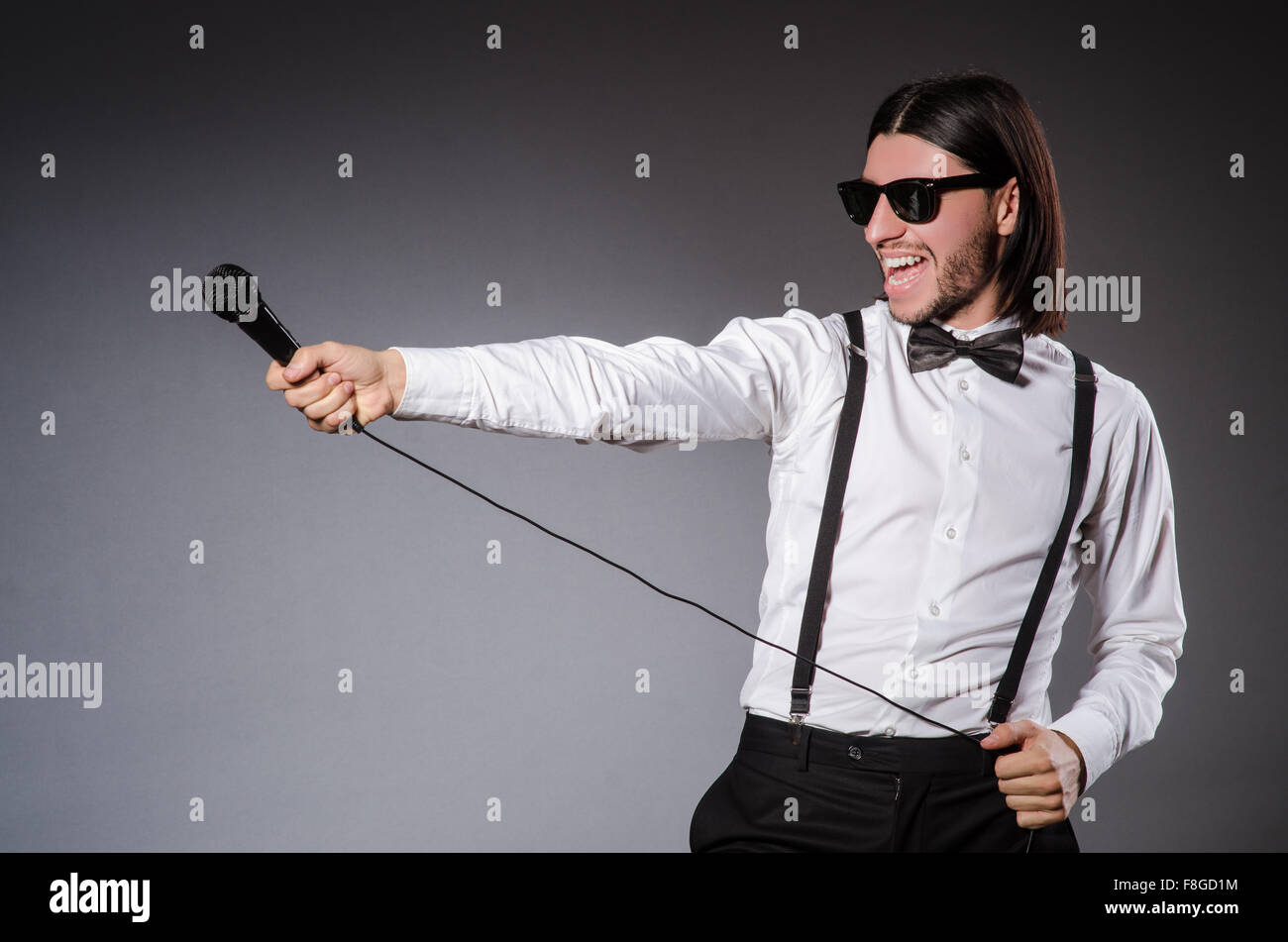 Funny singer with microphone at the concert Stock Photo - Alamy