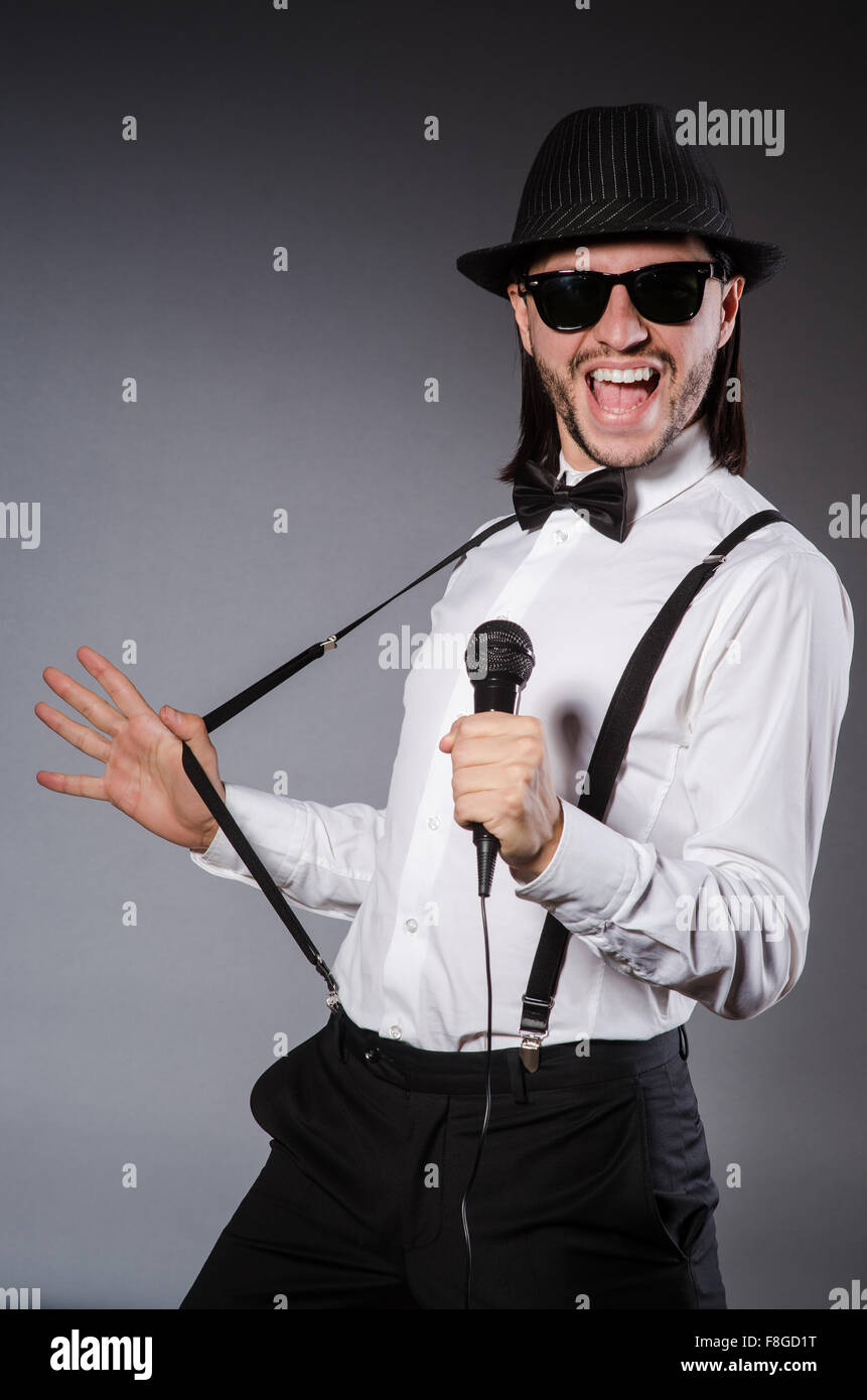 Funny singer with microphone at the concert Stock Photo - Alamy