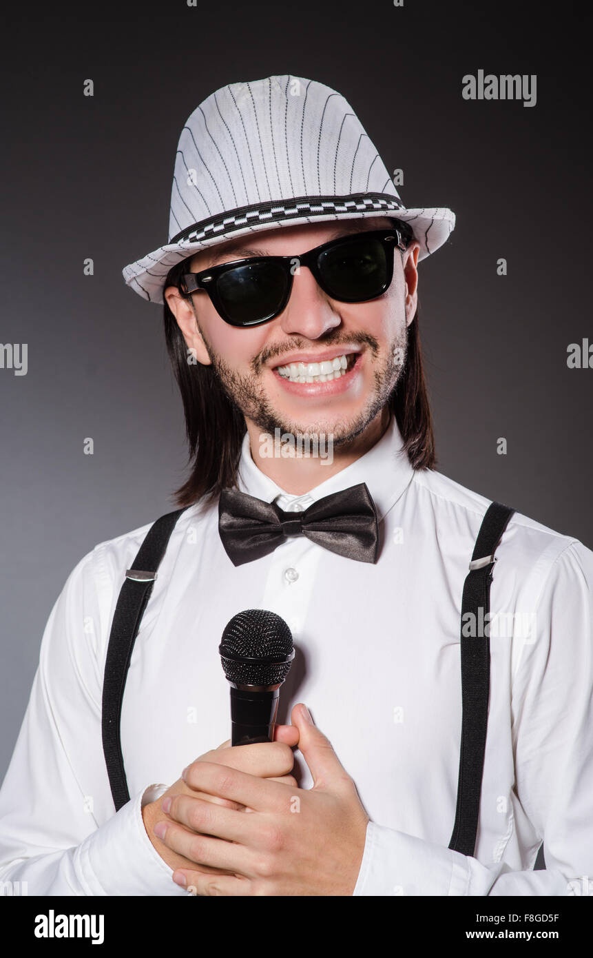 Funny singer with microphone at the concert Stock Photo - Alamy