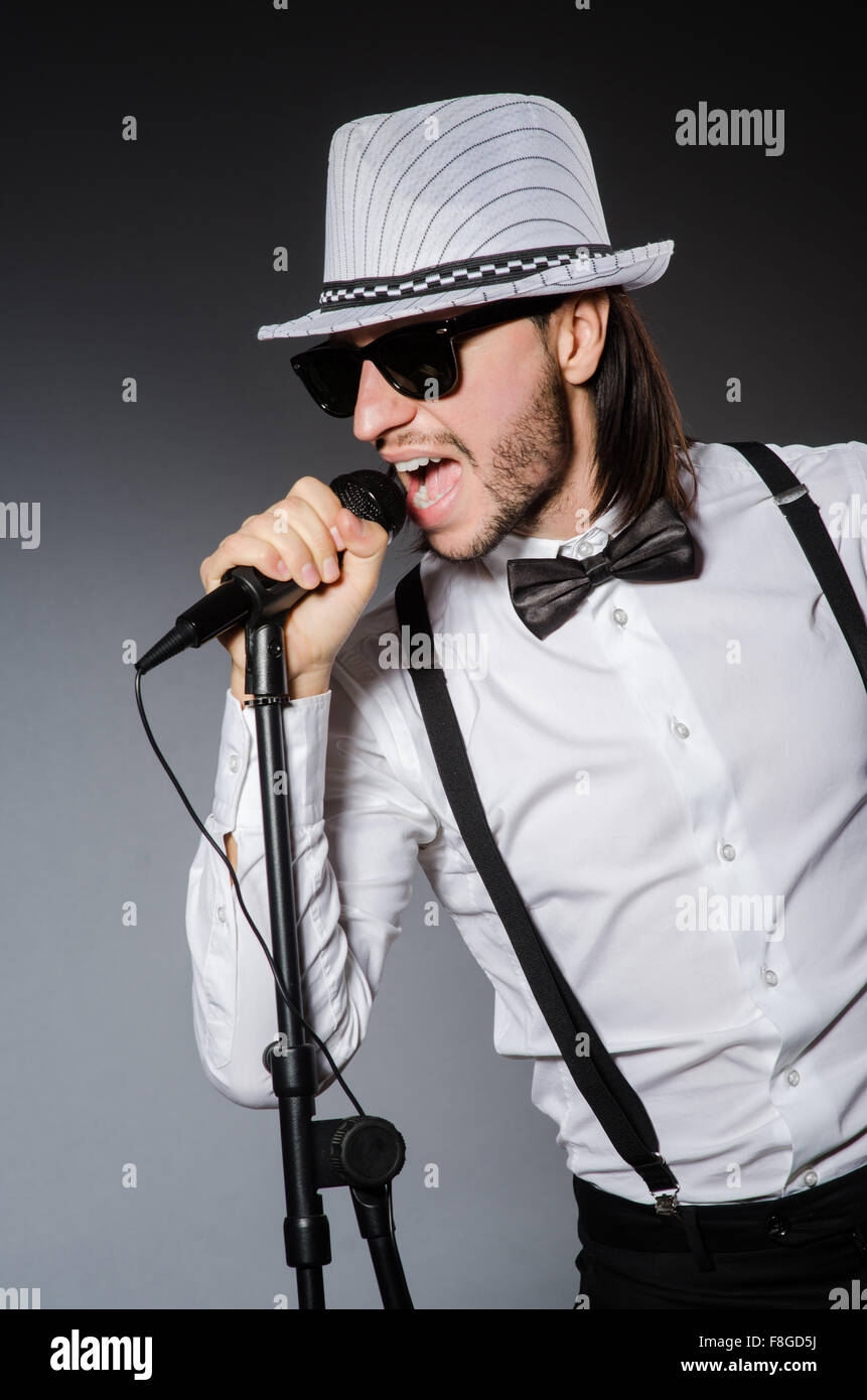 Funny singer with microphone at the concert Stock Photo - Alamy