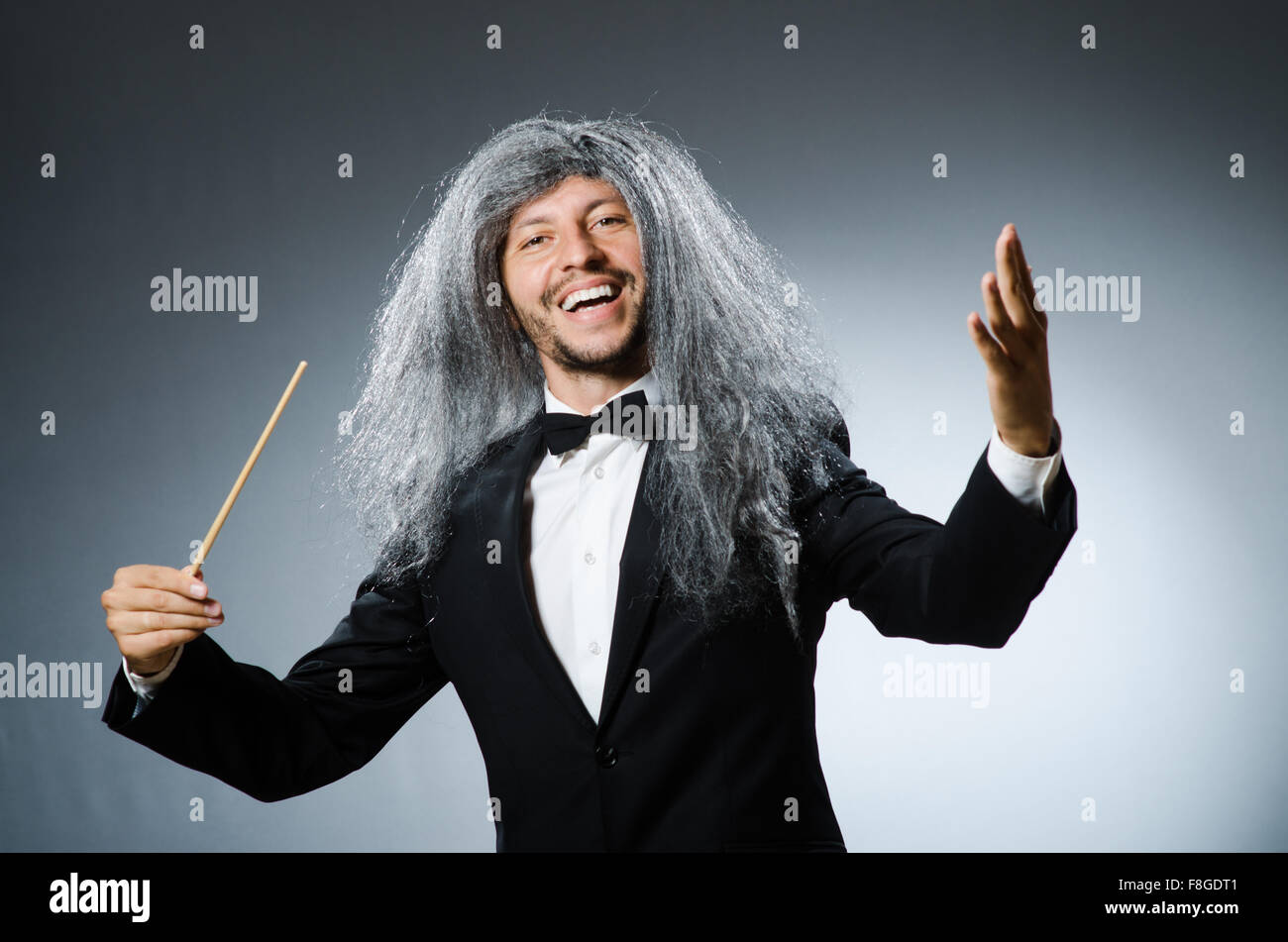 Funny conductor with long grey hair Stock Photo - Alamy