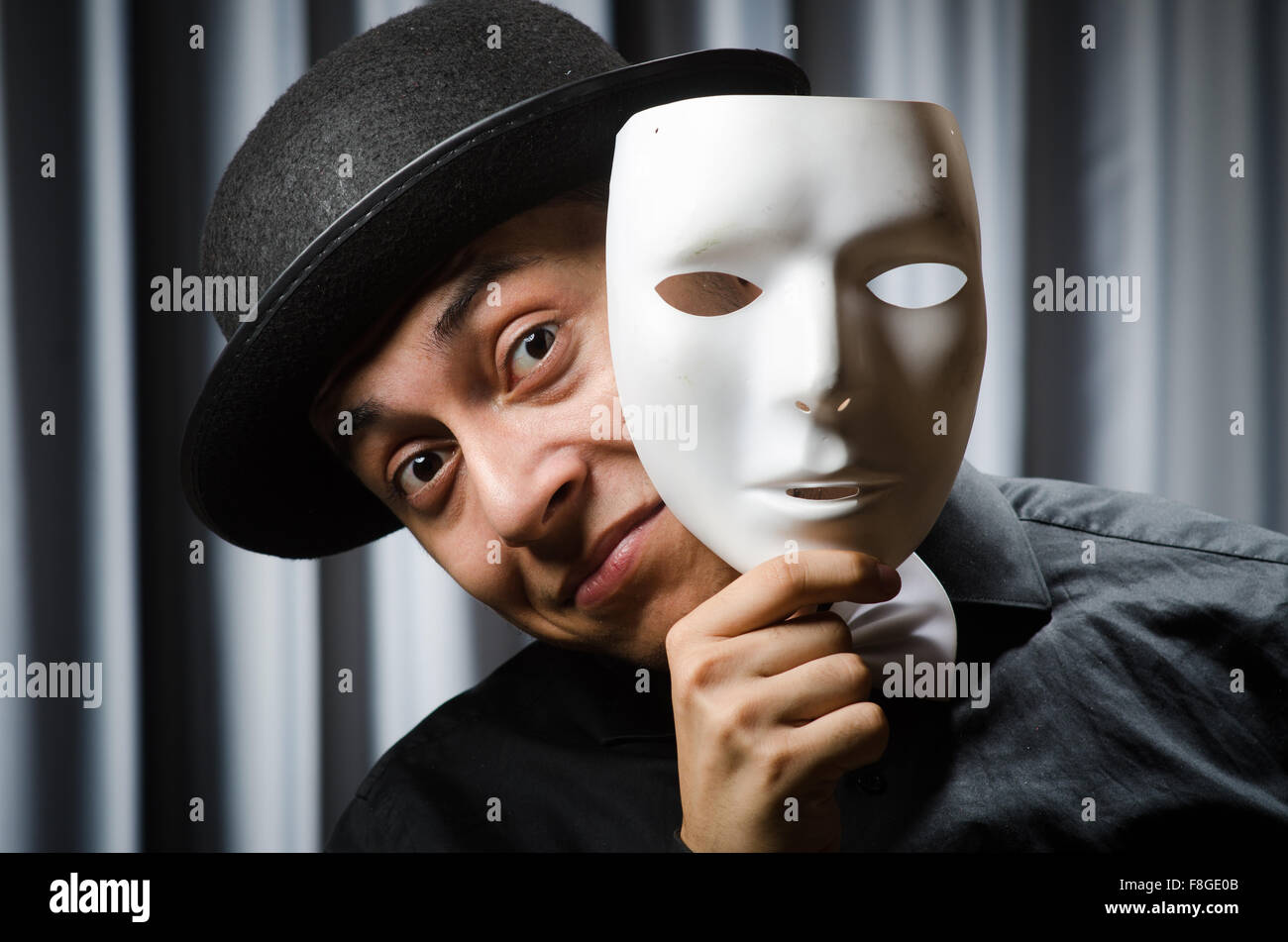 Funny concept with theatrical mask Stock Photo - Alamy