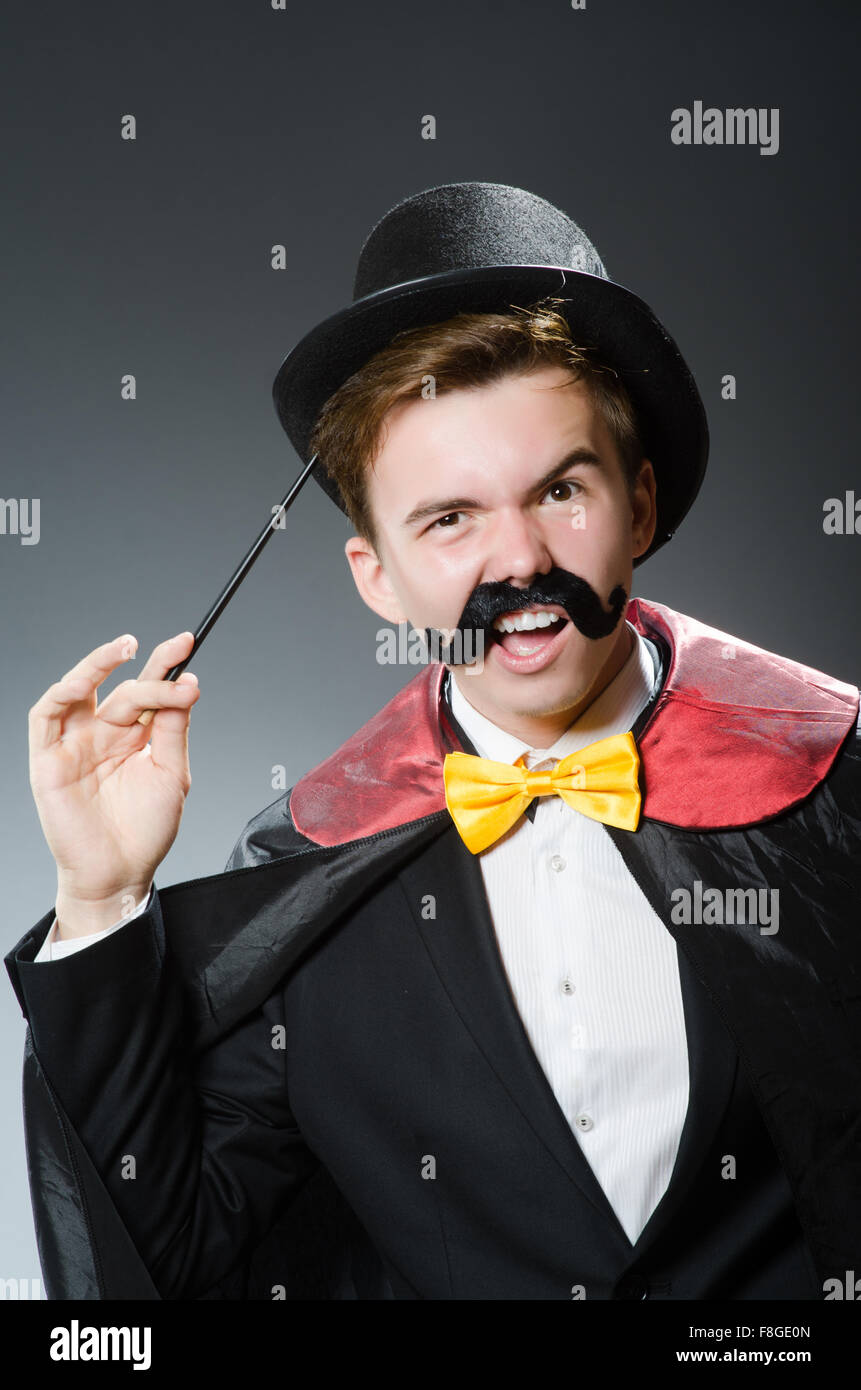 Funny magician with wand and hat Stock Photo - Alamy