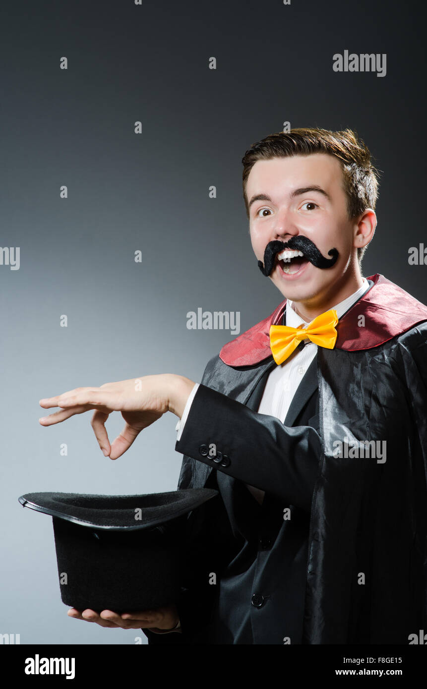 Funny magician with wand and hat Stock Photo - Alamy