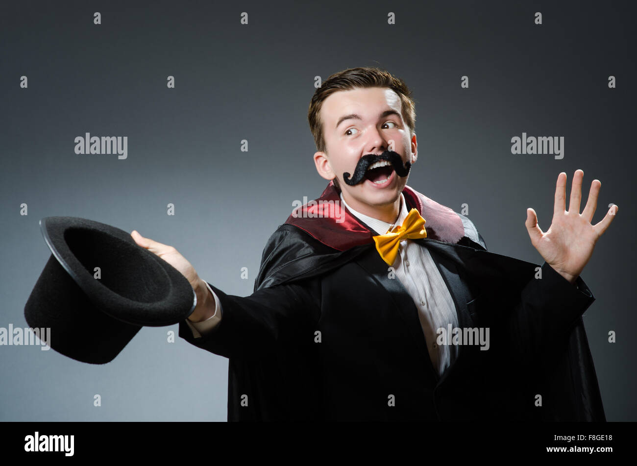 Funny magician with wand and hat Stock Photo - Alamy