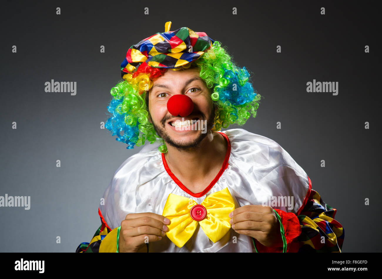 Funny clown in colourful costume Stock Photo - Alamy