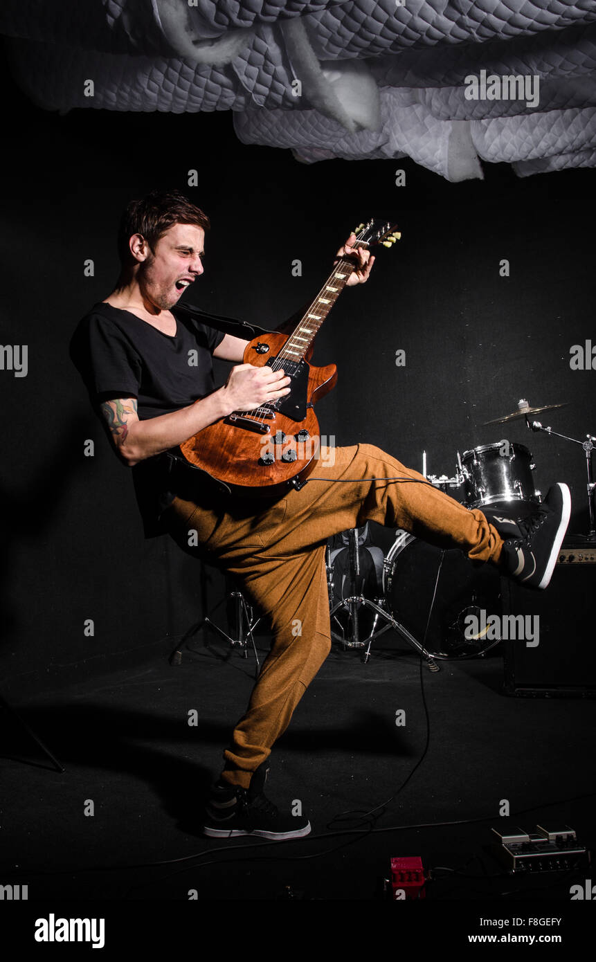 Man with guitar during concert Stock Photo - Alamy