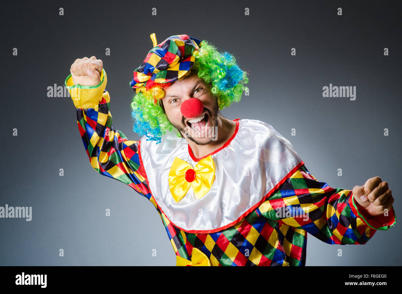 Funny clown in colourful costume Stock Photo - Alamy