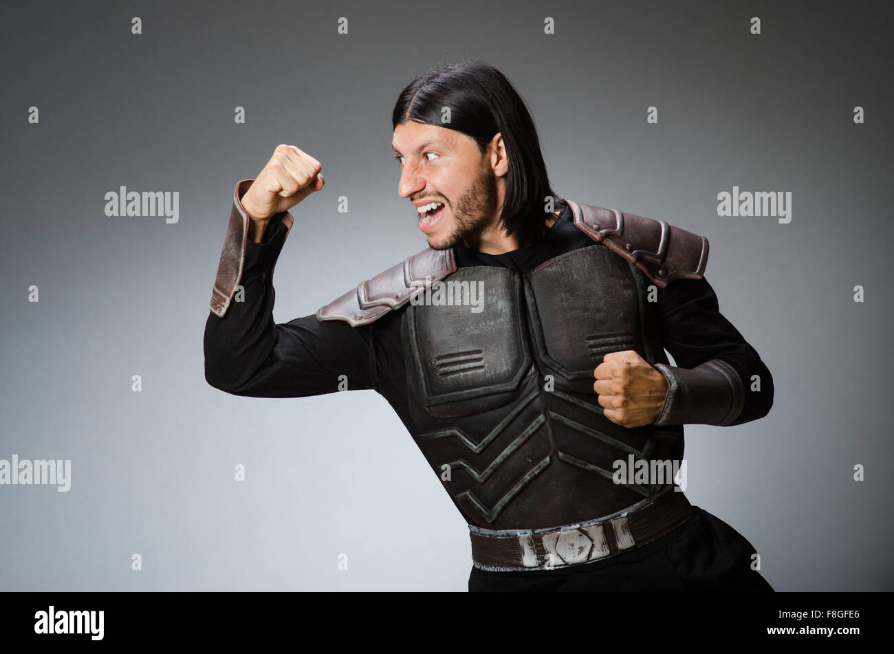 Angry warrior against dark background Stock Photo - Alamy