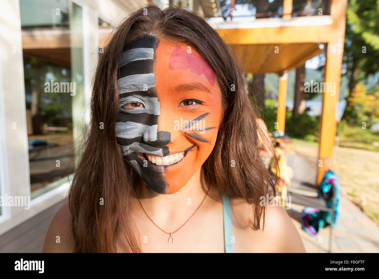 Smiling mixed race girl wearing face paint Stock Photo - Alamy