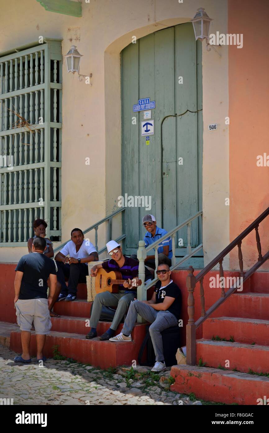 Cuban guys hanging out on the shady steps of a Casa Particulares with a ...