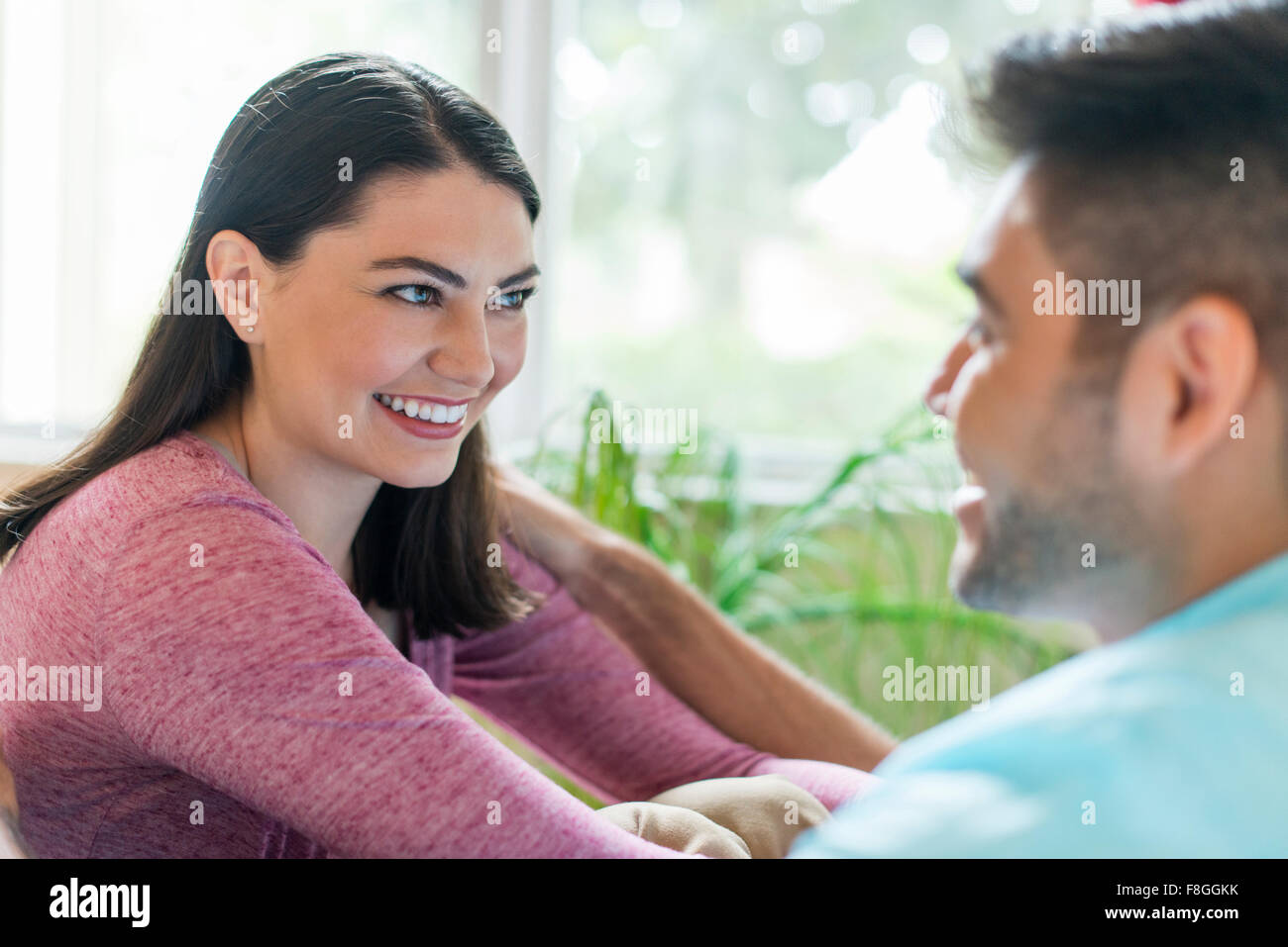 Hispanic couple talking indoors Stock Photo - Alamy