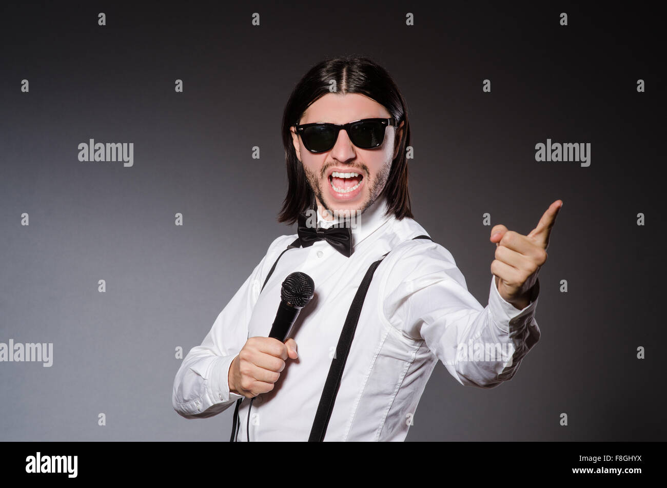 Funny singer with microphone at the concert Stock Photo - Alamy