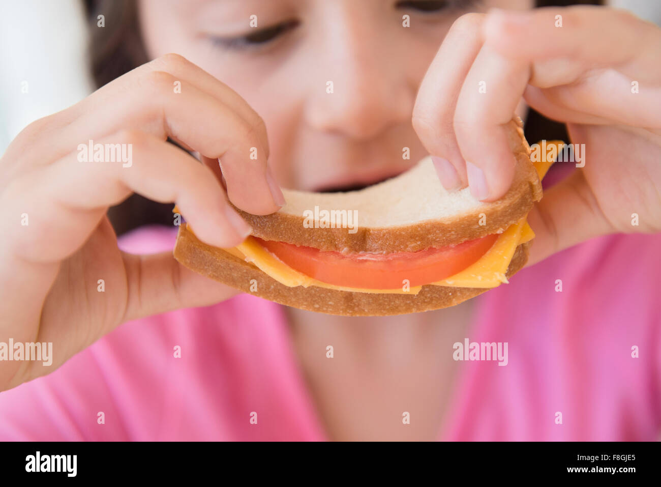 Close up of girl eating sandwich Stock Photo - Alamy