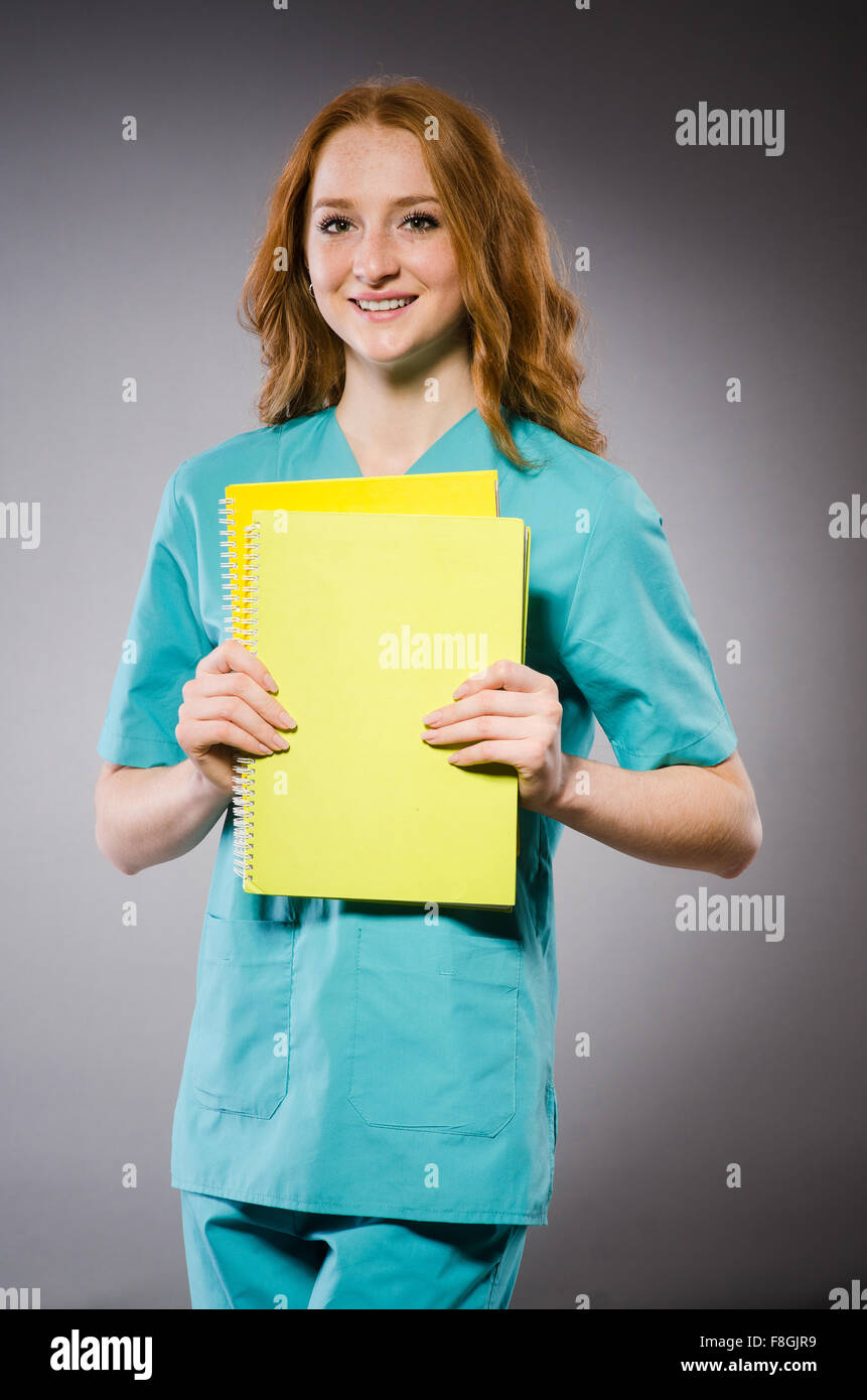 Young woman doctor with book Stock Photo - Alamy
