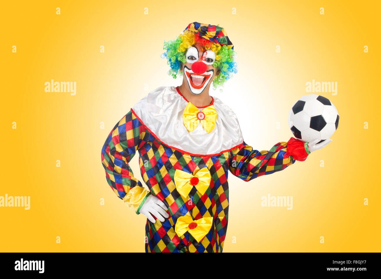 Clown with football ball on white Stock Photo - Alamy