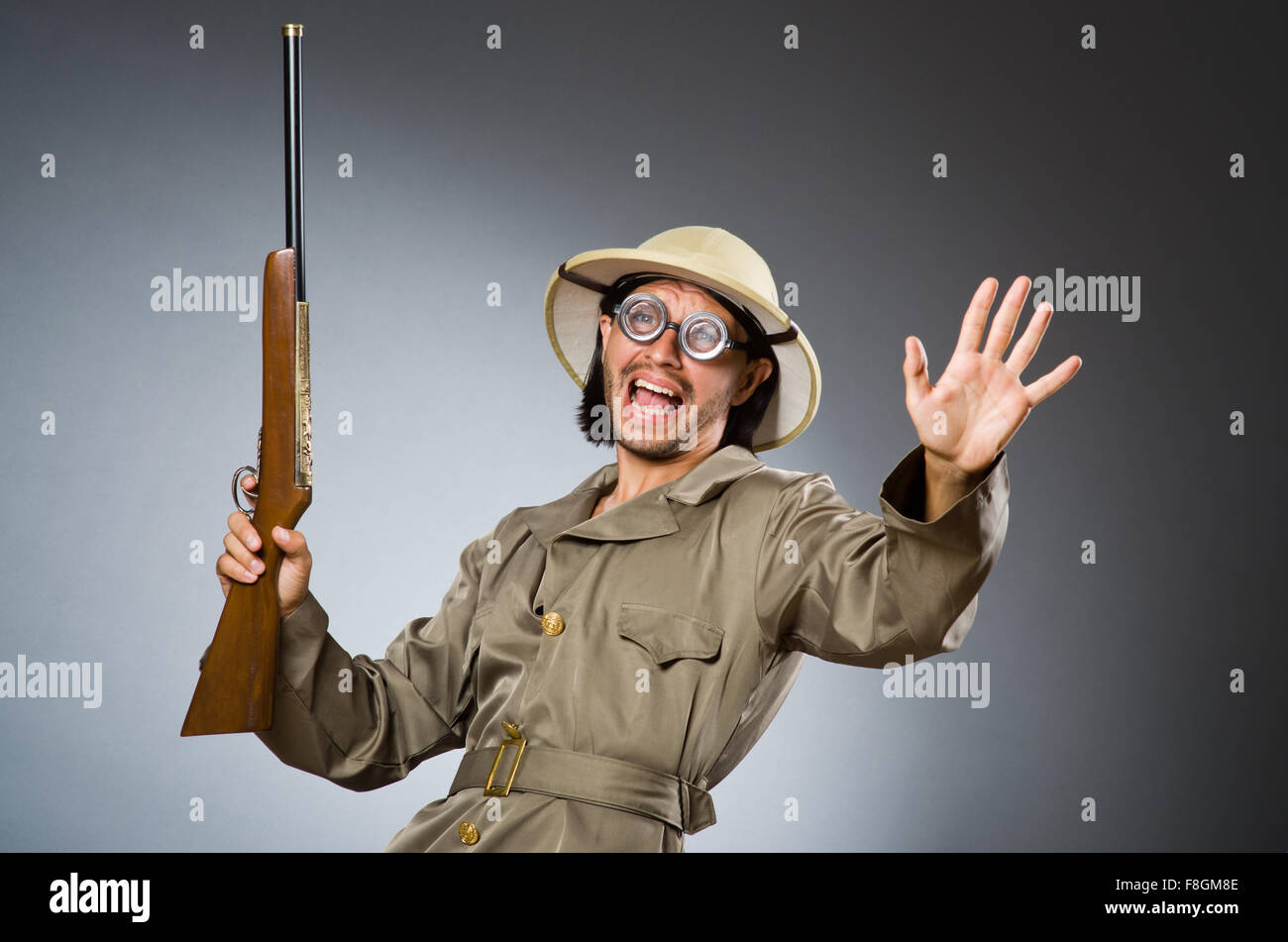 Funny safari hunter with rifle Stock Photo - Alamy