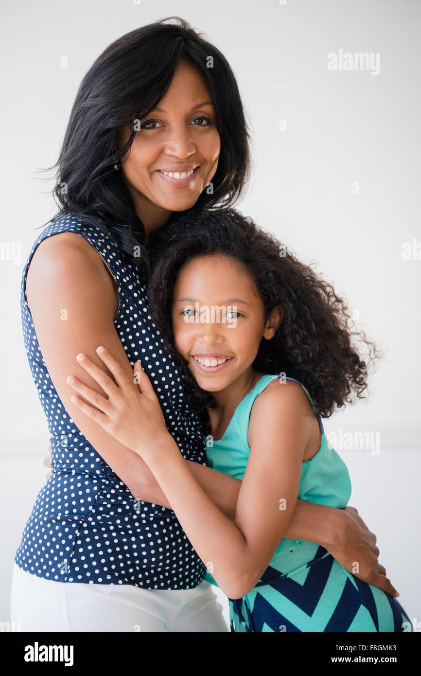 Mother and daughter hugging Stock Photo - Alamy