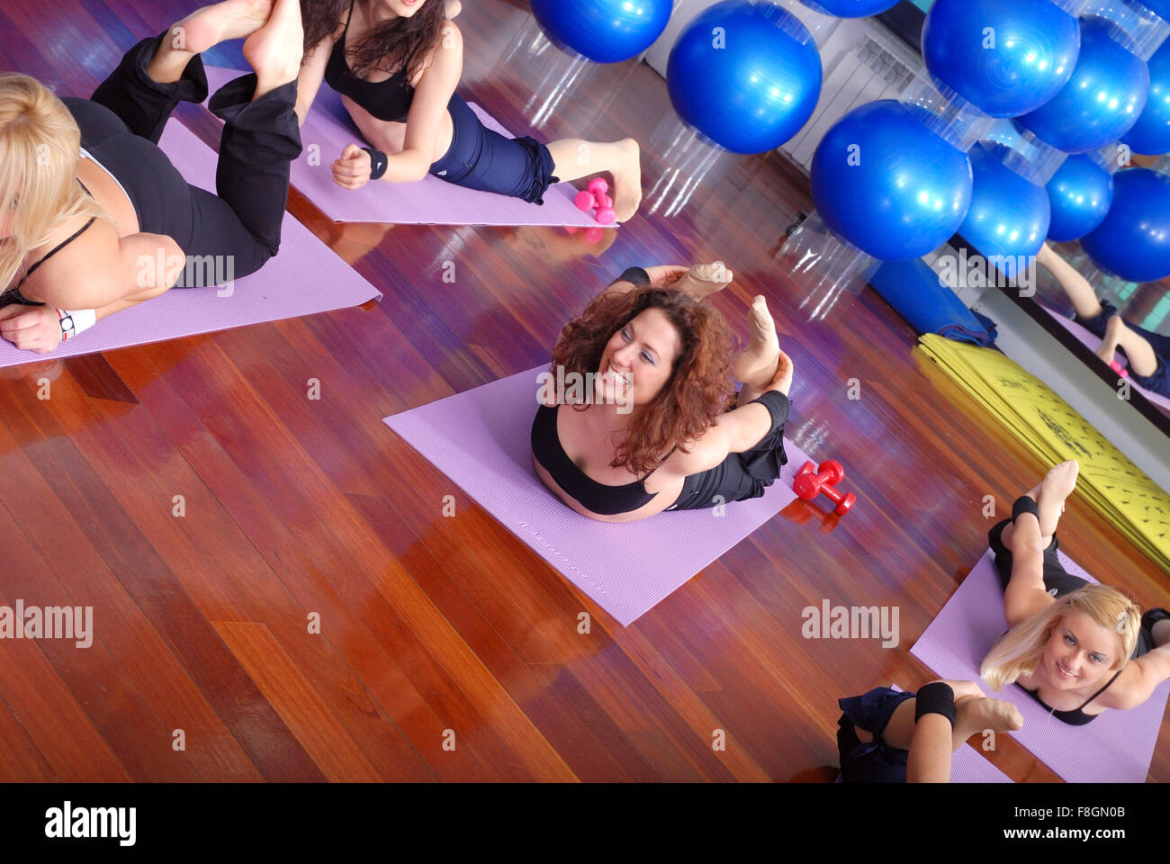 health club: women doing stretching, fitness, aerobics and yoga ...