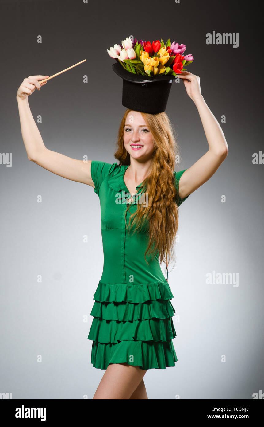 Woman magician wearing green dress Stock Photo - Alamy